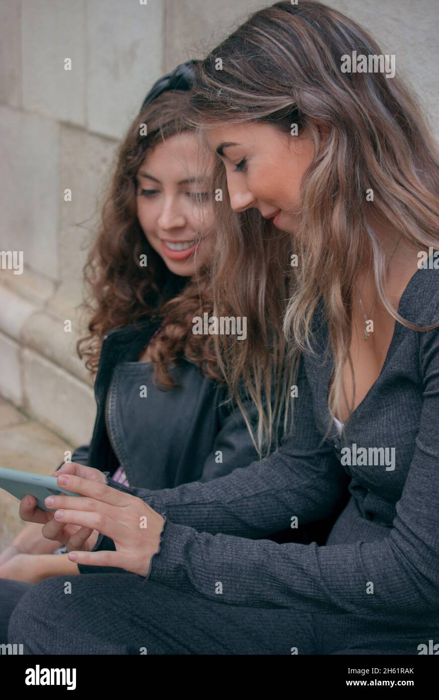Two best friends smile happily spending time together while looking ...