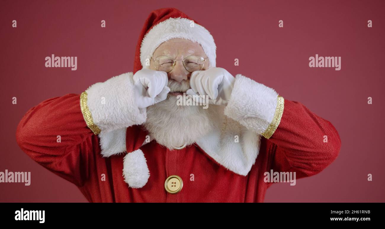 Santa Claus crying with his hands in his eyes Stock Photo - Alamy