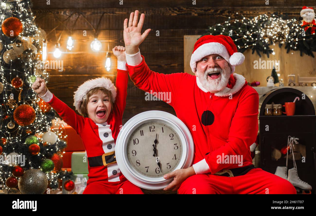 Santa Claus and little helper with clock waving hand and celebration ...