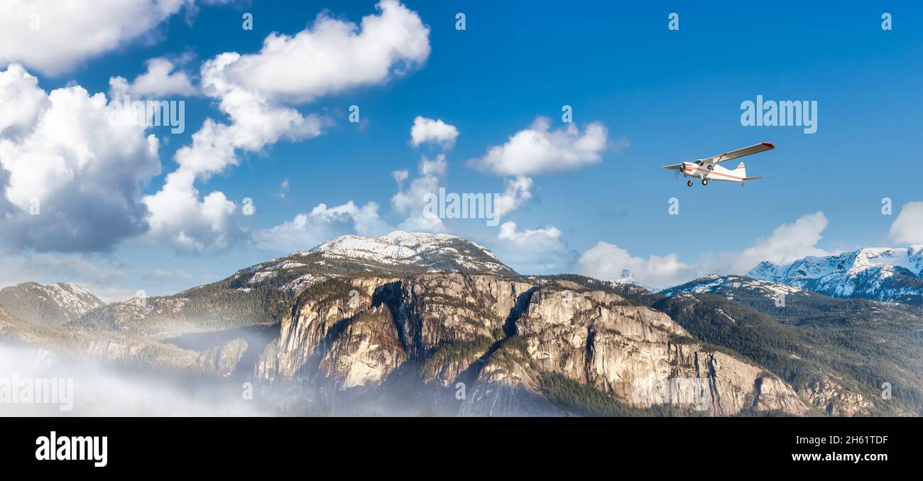 Airplane flying over the mountain landscape during cloudy day Stock ...