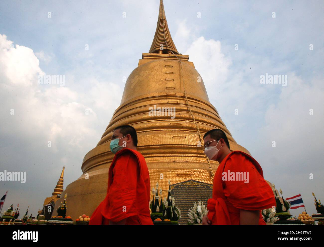 Buddhist monks wearing face masks seen during the temple and wrapped ...
