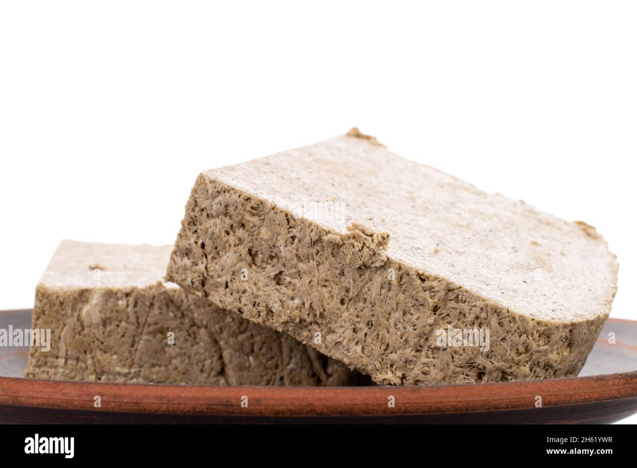 Pieces of sweet halva with vanilla on a shale stone, close-up, isolated ...