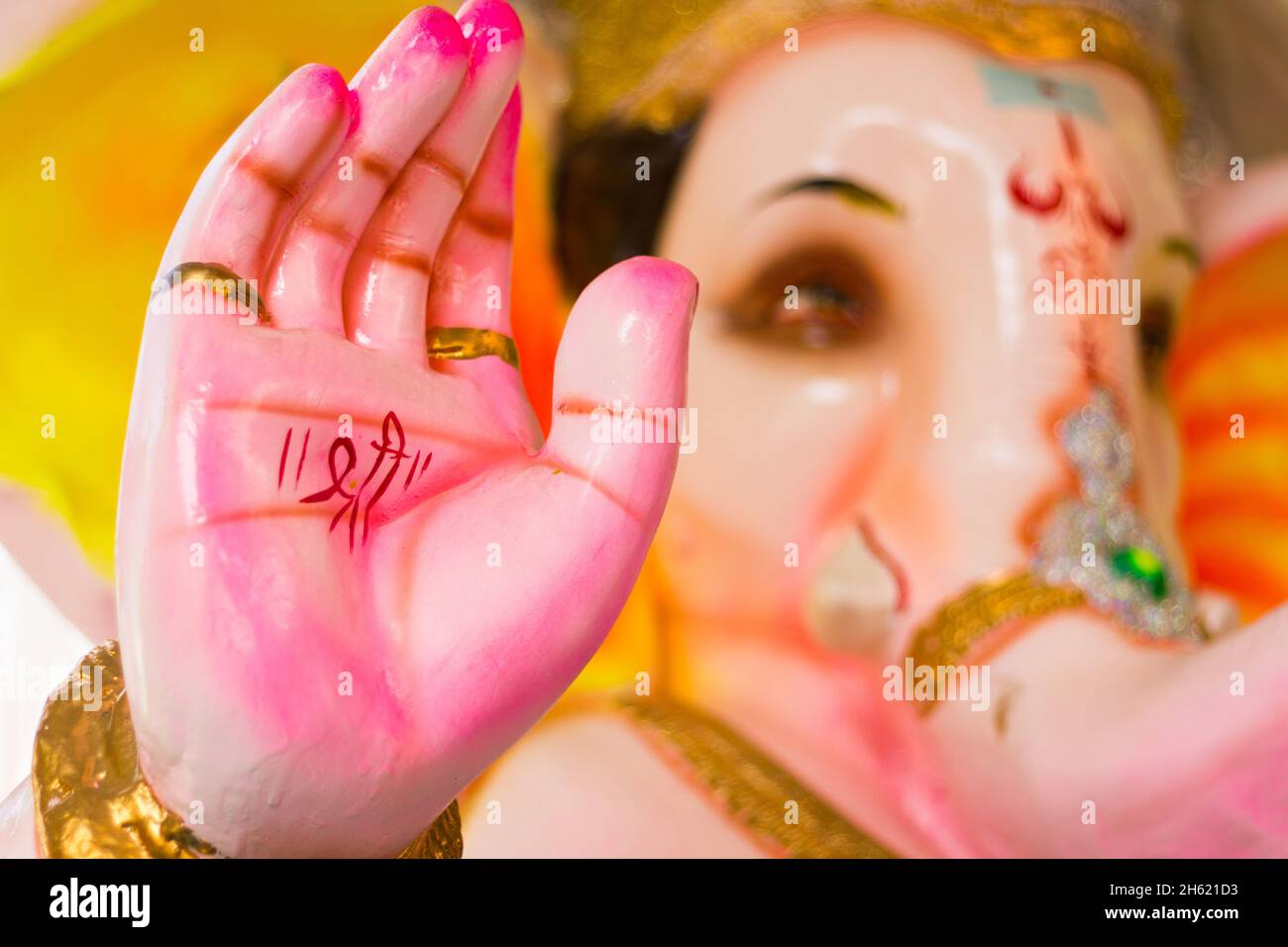 Close up on hand of God Ganesha colorful elephant statue to celebrate ...