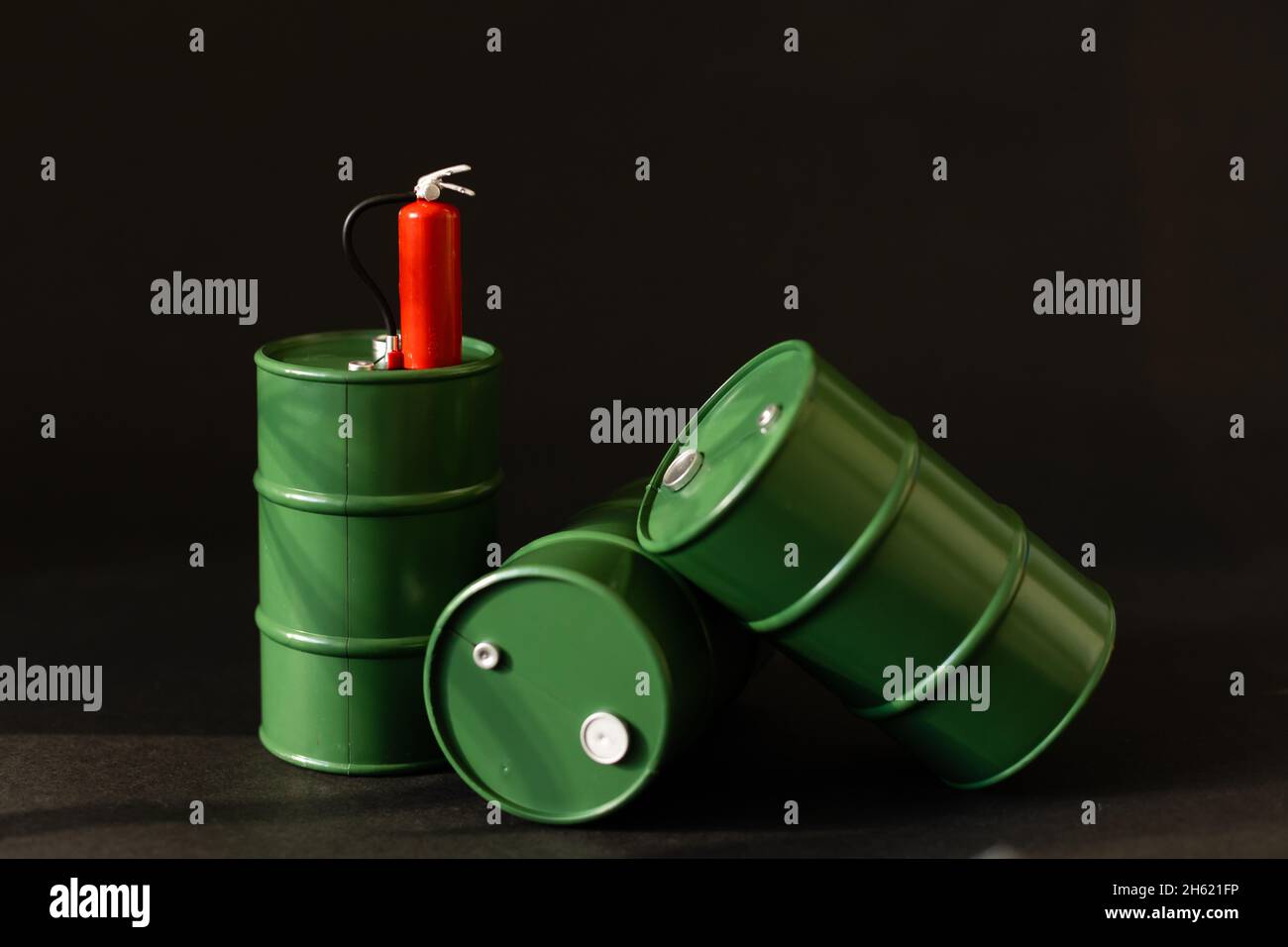 tin barrels and fire extinguisher on black background Stock Photo - Alamy