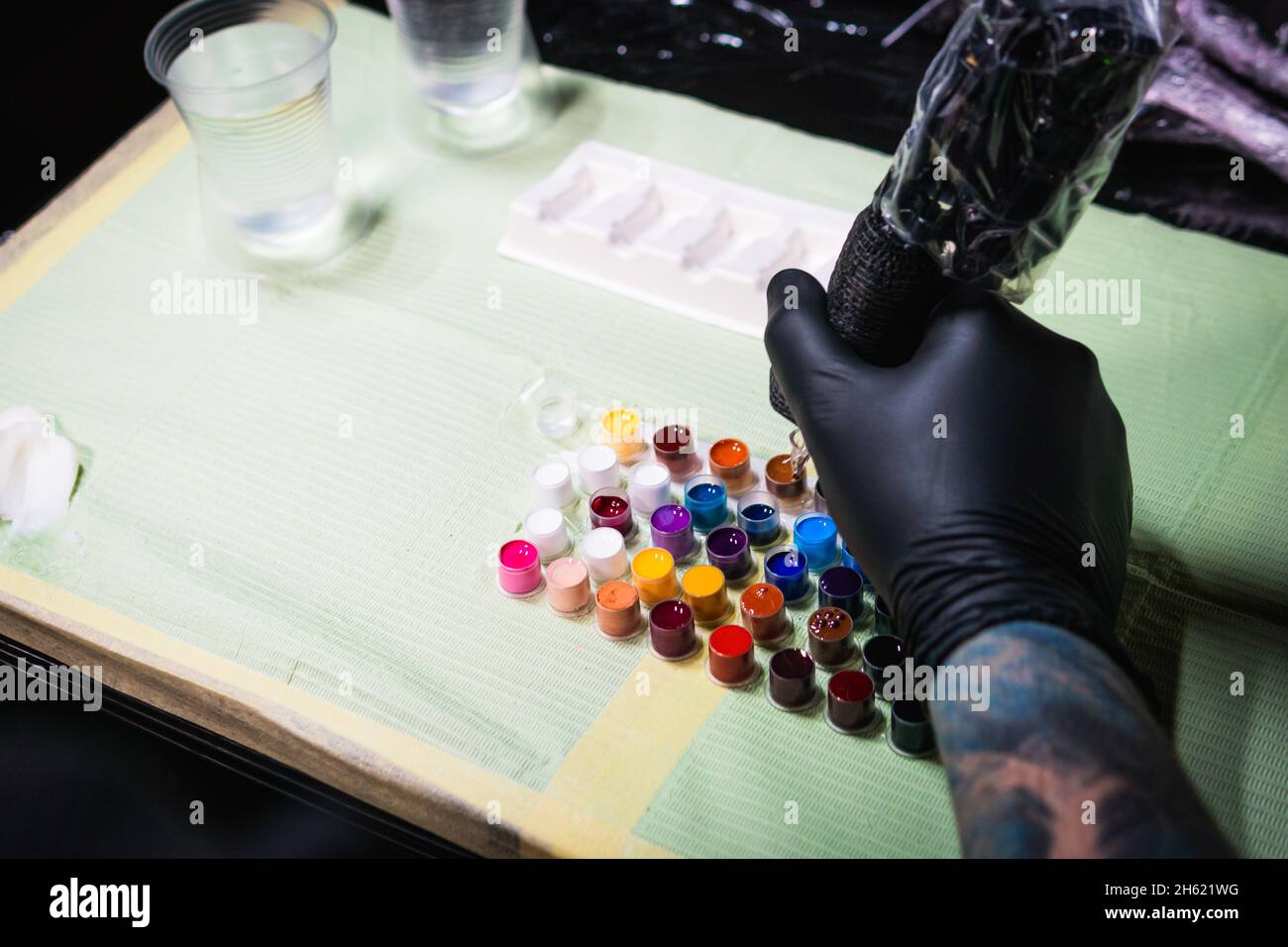 Close-up of tattoo artist work place parts and paint, machines and ...