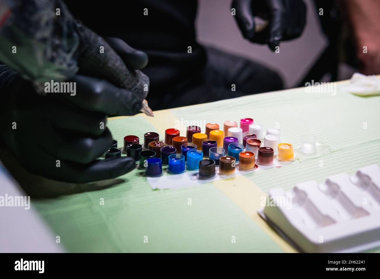 Close-up of tattoo artist work place parts and paint, machines and ...