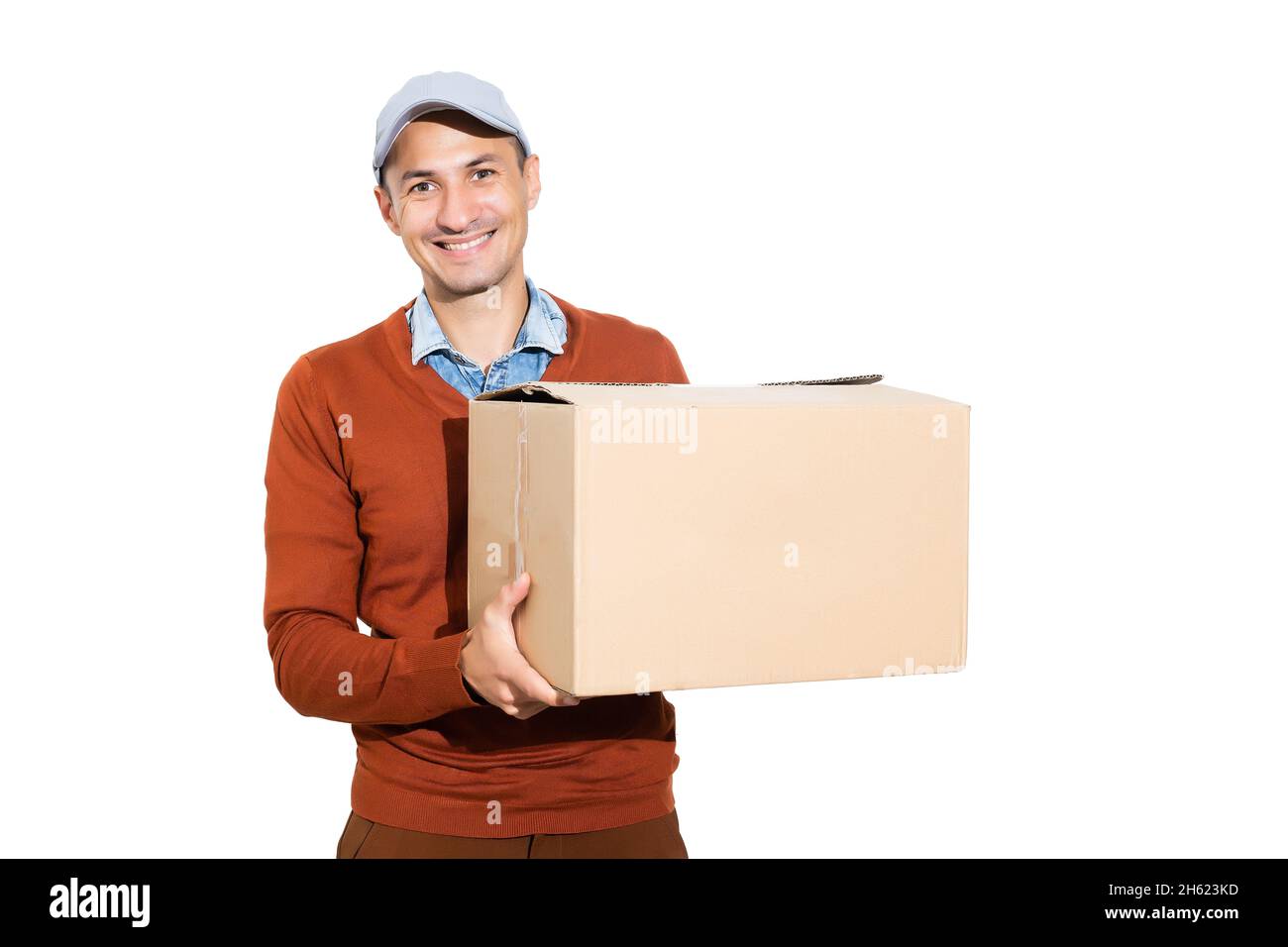 Smiling delivery man giving cardbox on white background Stock Photo - Alamy