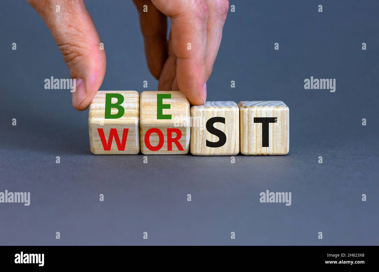 Best or worst symbol. Businessman turns wooden cubes and changes the ...
