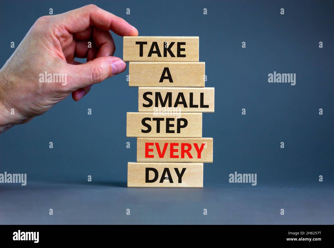 Take a small step every day symbol. Wooden blocks with words Take a ...
