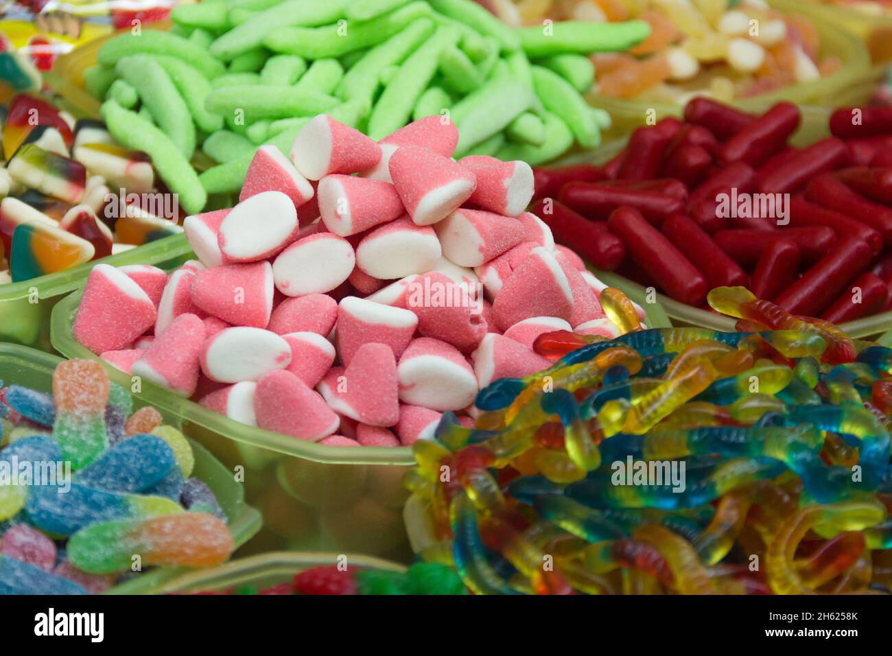 Variety of colorful candies. Pink gummies, sour jellybeans, gumdrop ...