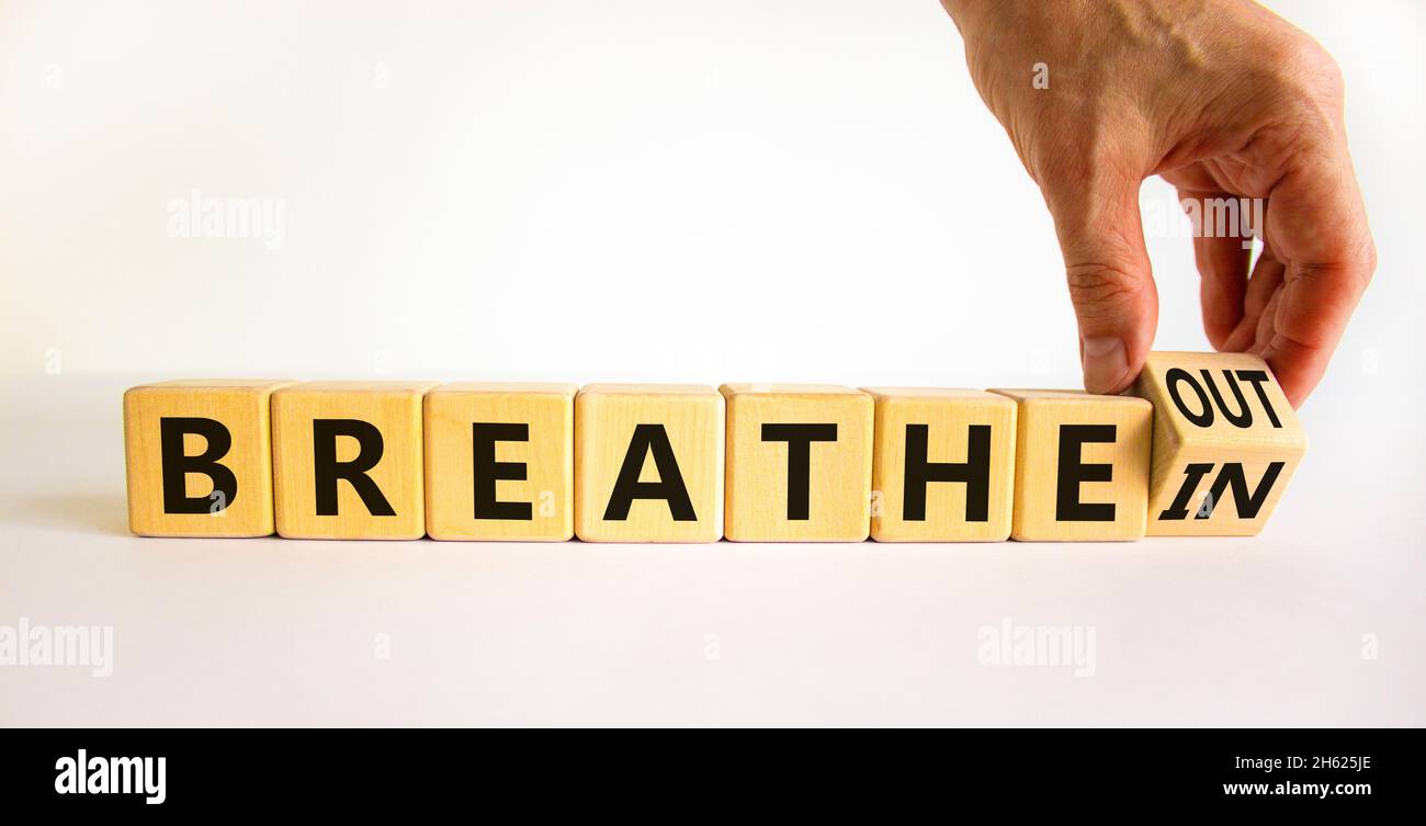 Breathe in and out symbol. Doctor turns a wooden cube and changes words ...