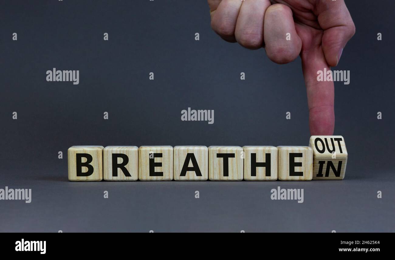 Breathe in and out symbol. Doctor turns a wooden cube and changes words ...