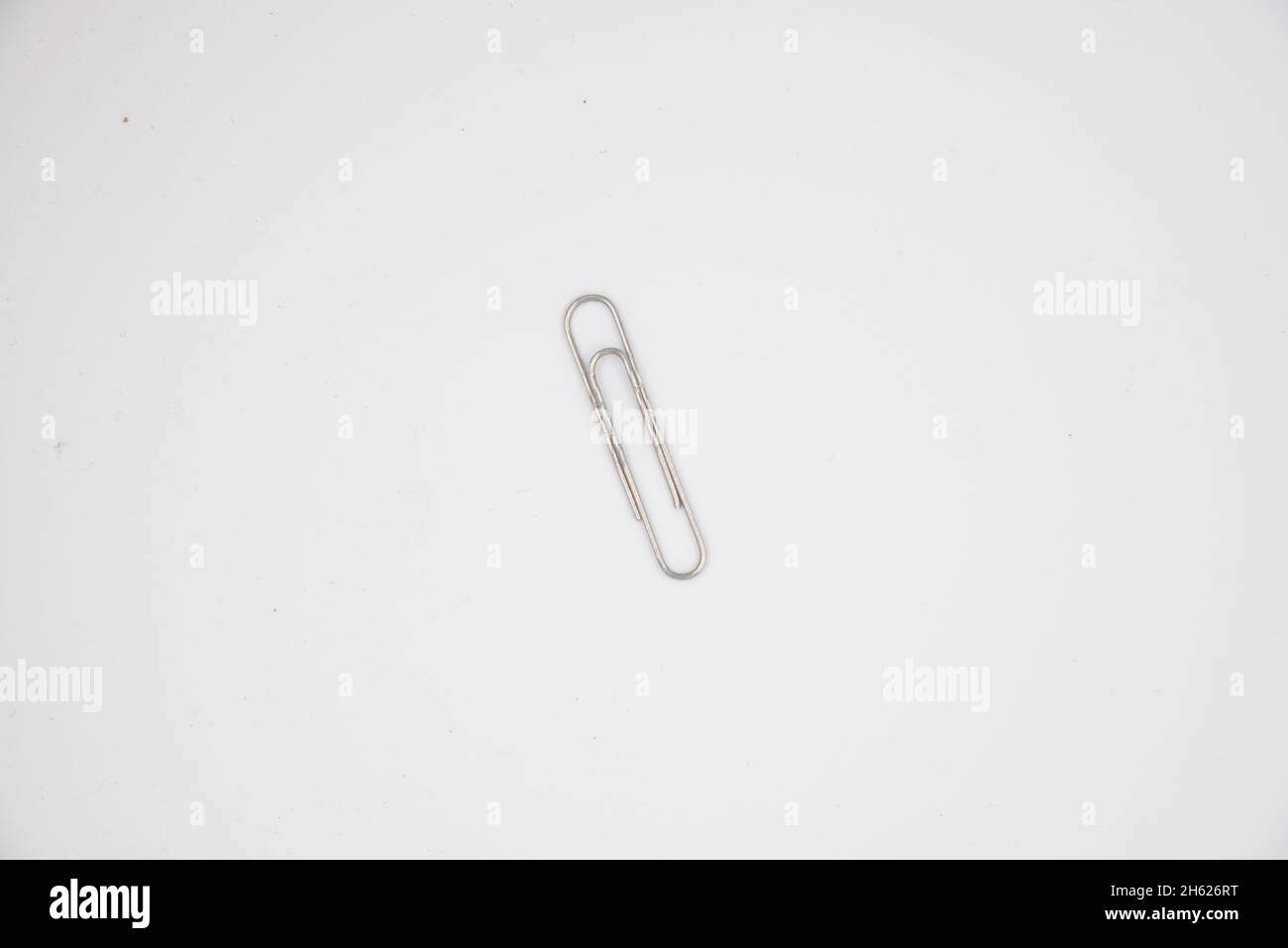 Paper clip on a white background Stock Photo - Alamy