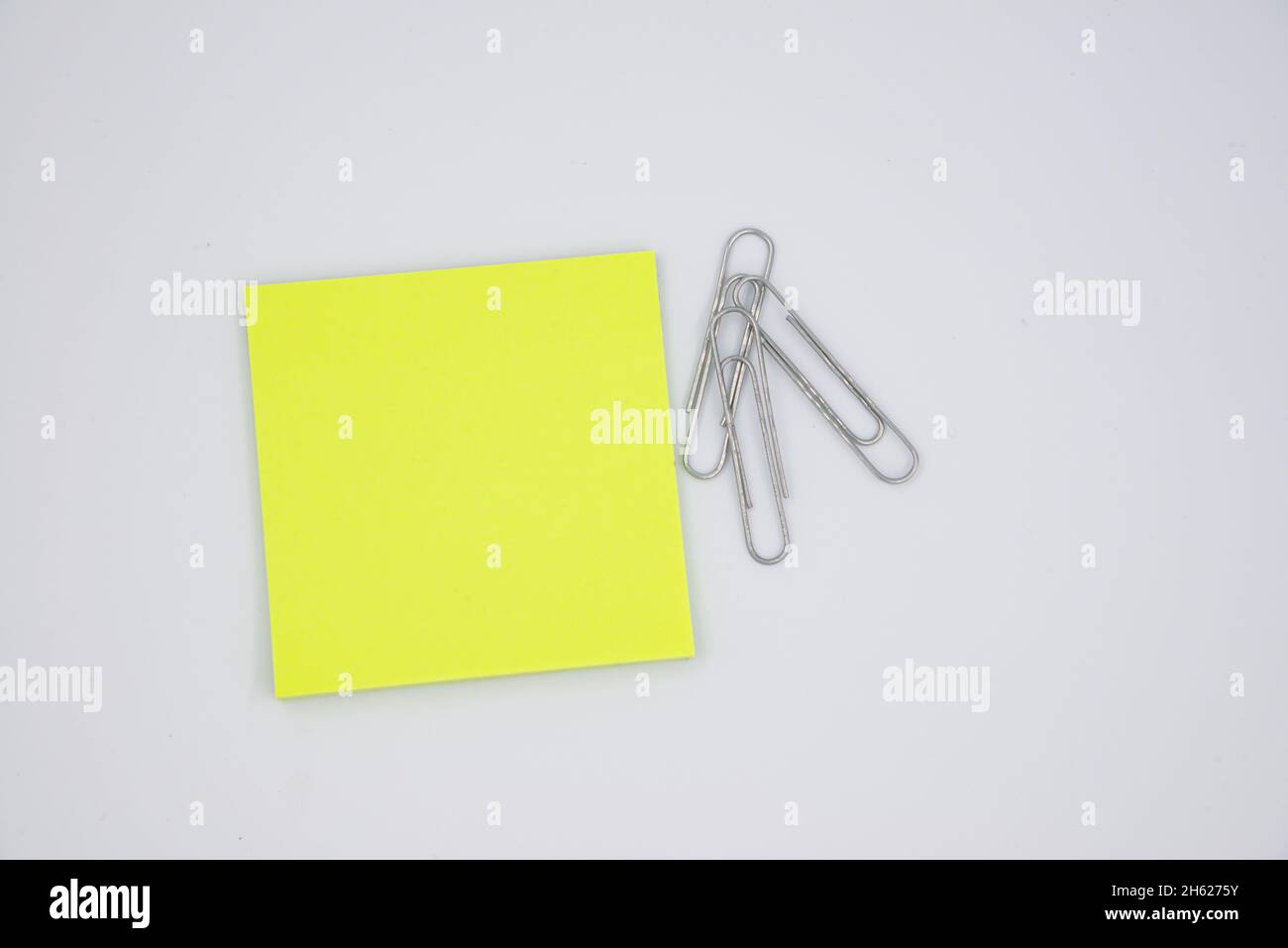 Neon yellow paper note with metal clips isolated on white Stock Photo ...