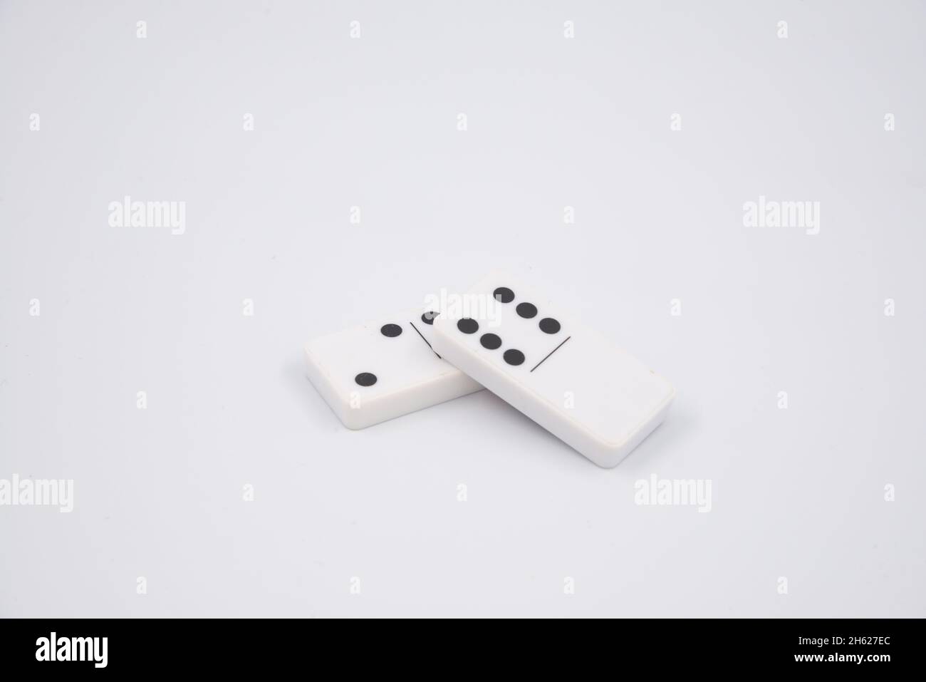 Two classic domino tiles on white background Stock Photo - Alamy