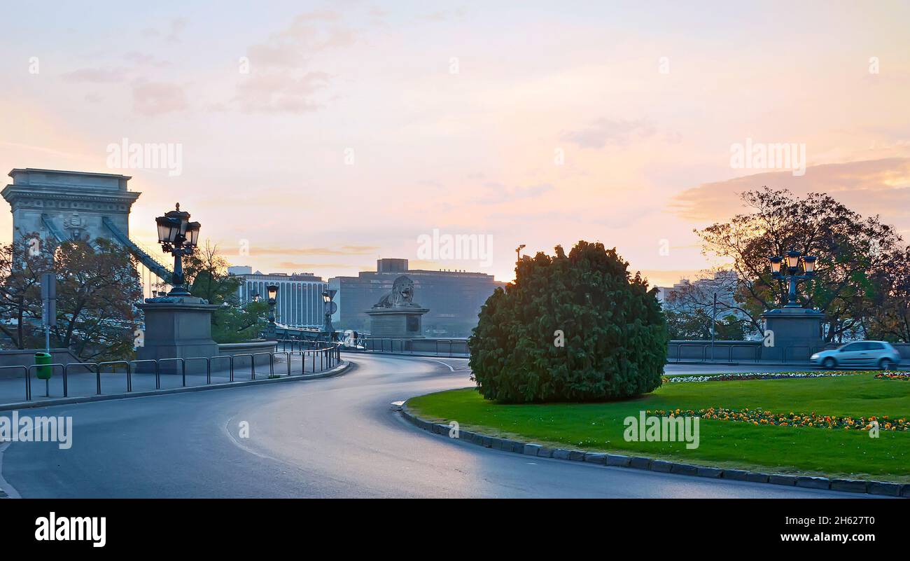 The scenic sunrise over the stone Chain Bridge with lion sculptures and ...