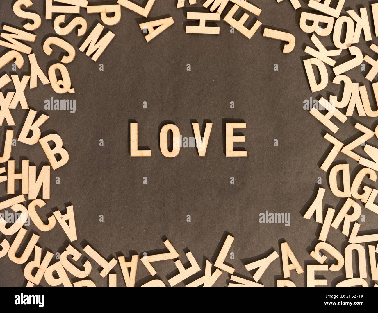 Love Word In Wooden Cube Alphabet Letters Top View On A rustic paper ...