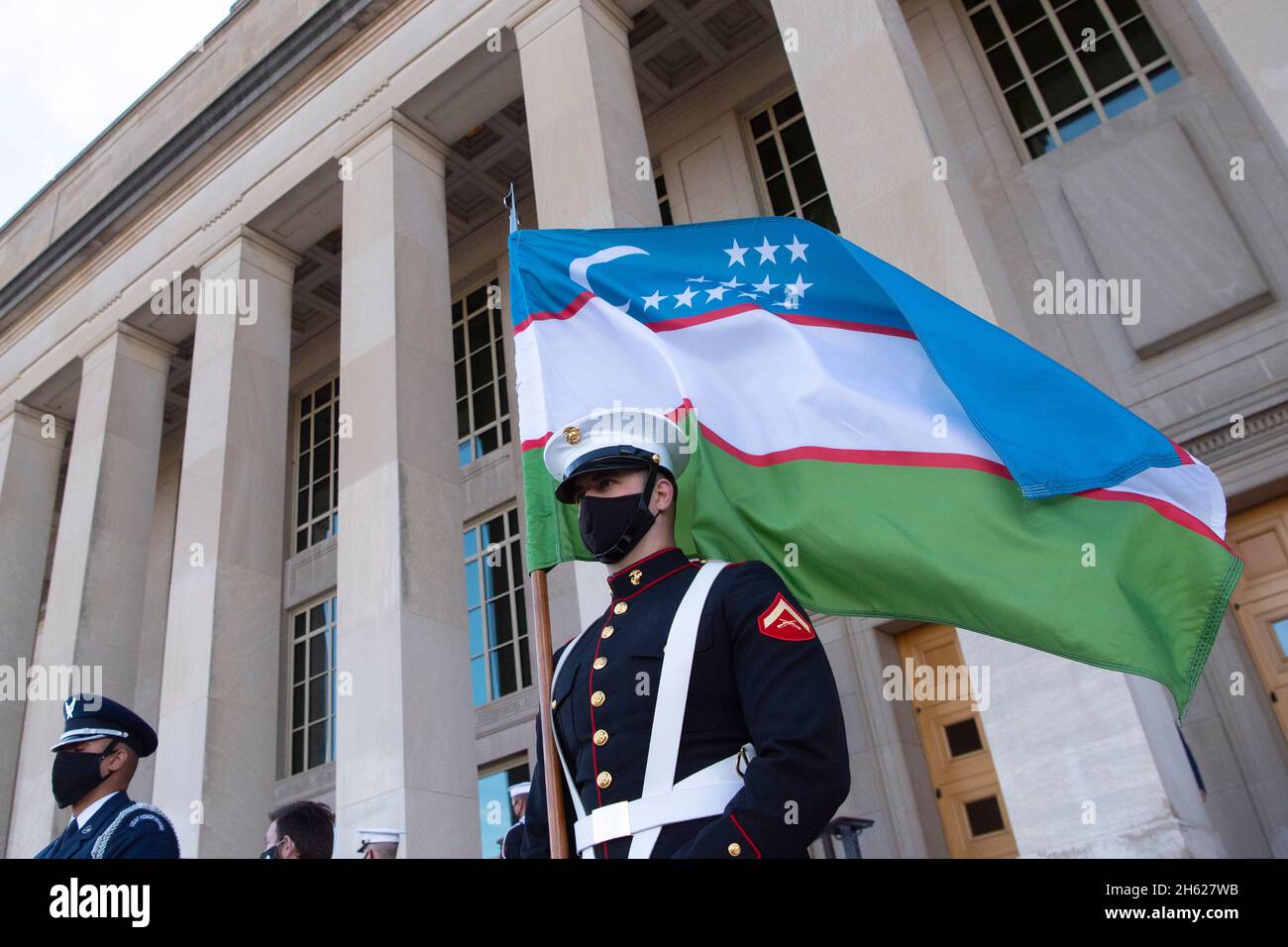 Reportage: A Marine in the Joint Honor Guard holds Uzbekistanâ€™s flag ...