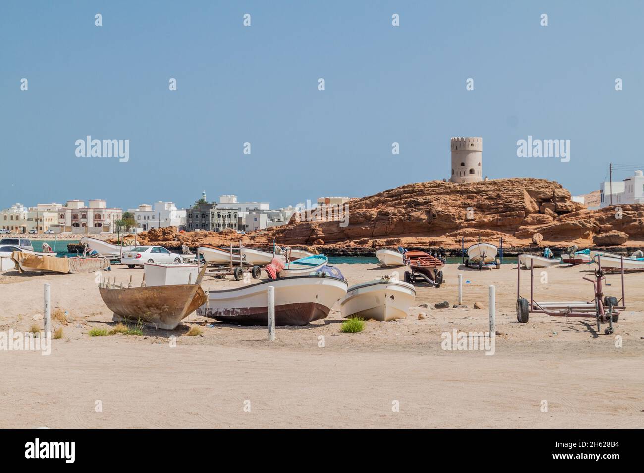 Fishing boats in Sur, Oman. Watchtower in Ayjah village in the ...