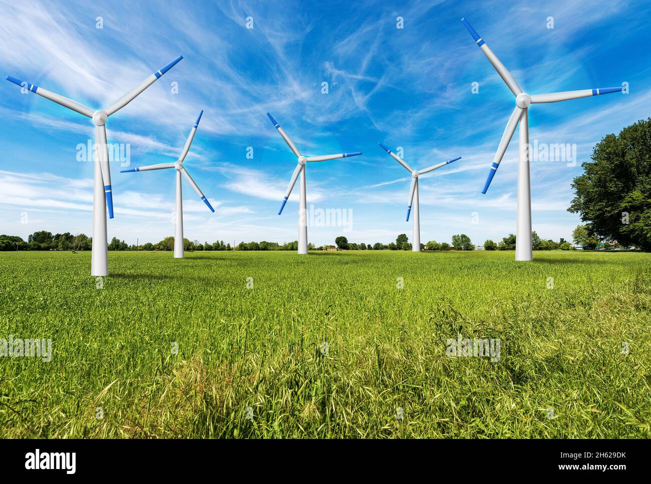 Group of white and blue wind turbines in a rural landscape with a green ...