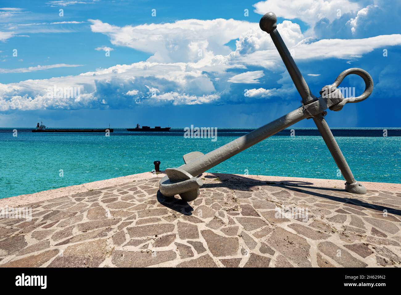Large anchor on the shore of the sea with beautiful seascape on ...