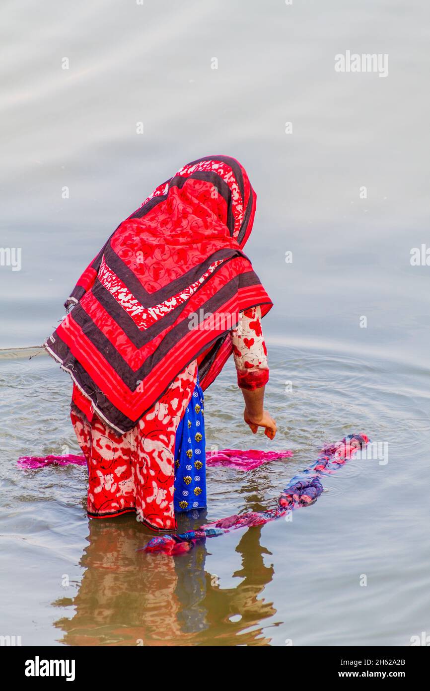 SONA MASJID, BANGLADESH - NOVEMBER 11, 2016: Local woman washing ...