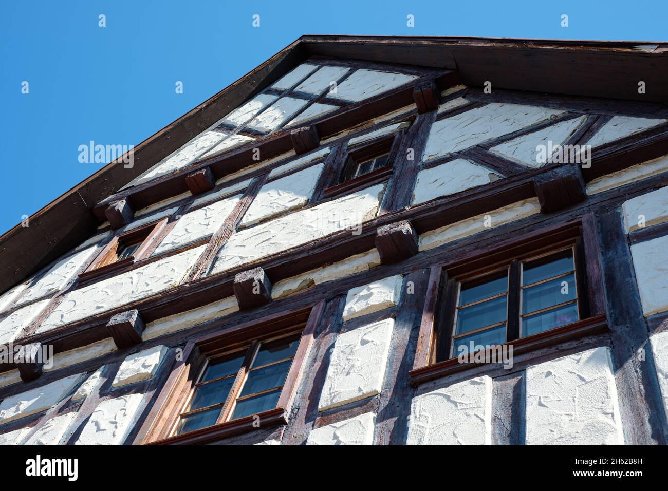 Low angle of a House with wooden half timbered with windows against a ...