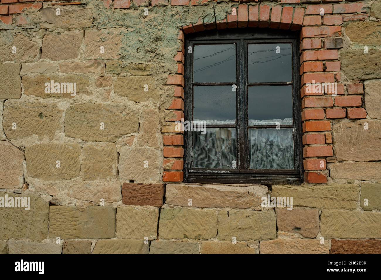 Wooden window at a sandstone wall with bricks Stock Photo - Alamy
