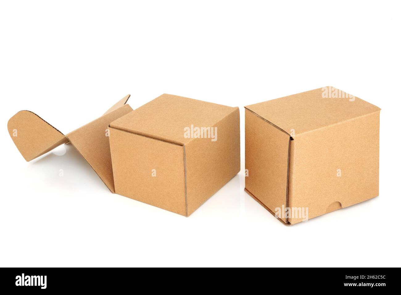 Two cube shaped cardboard box containers one with lid open, one shut on ...