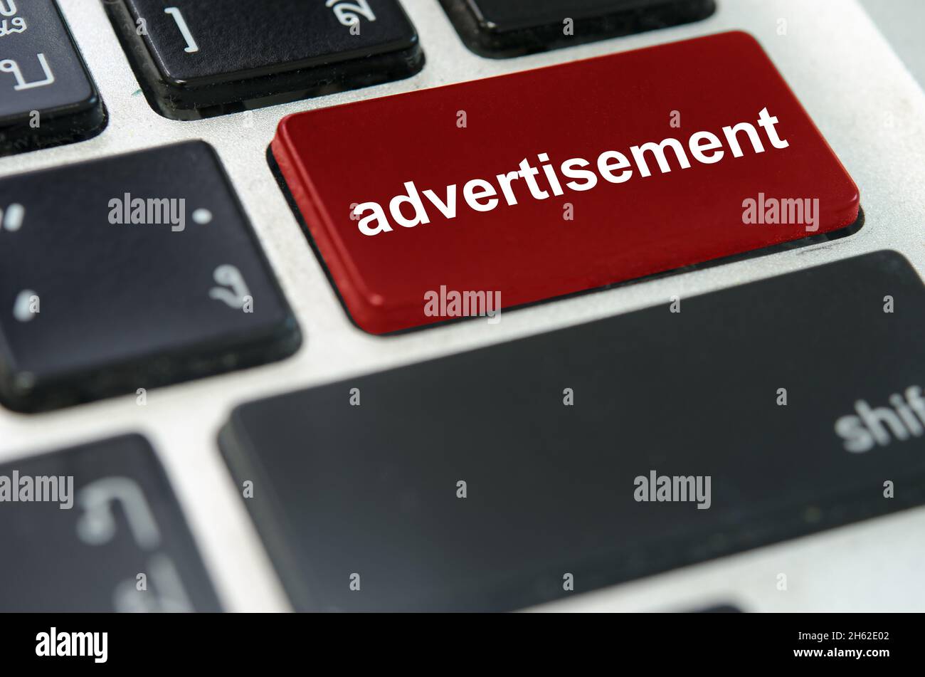 A keyboard with a red button advertisement Stock Photo - Alamy