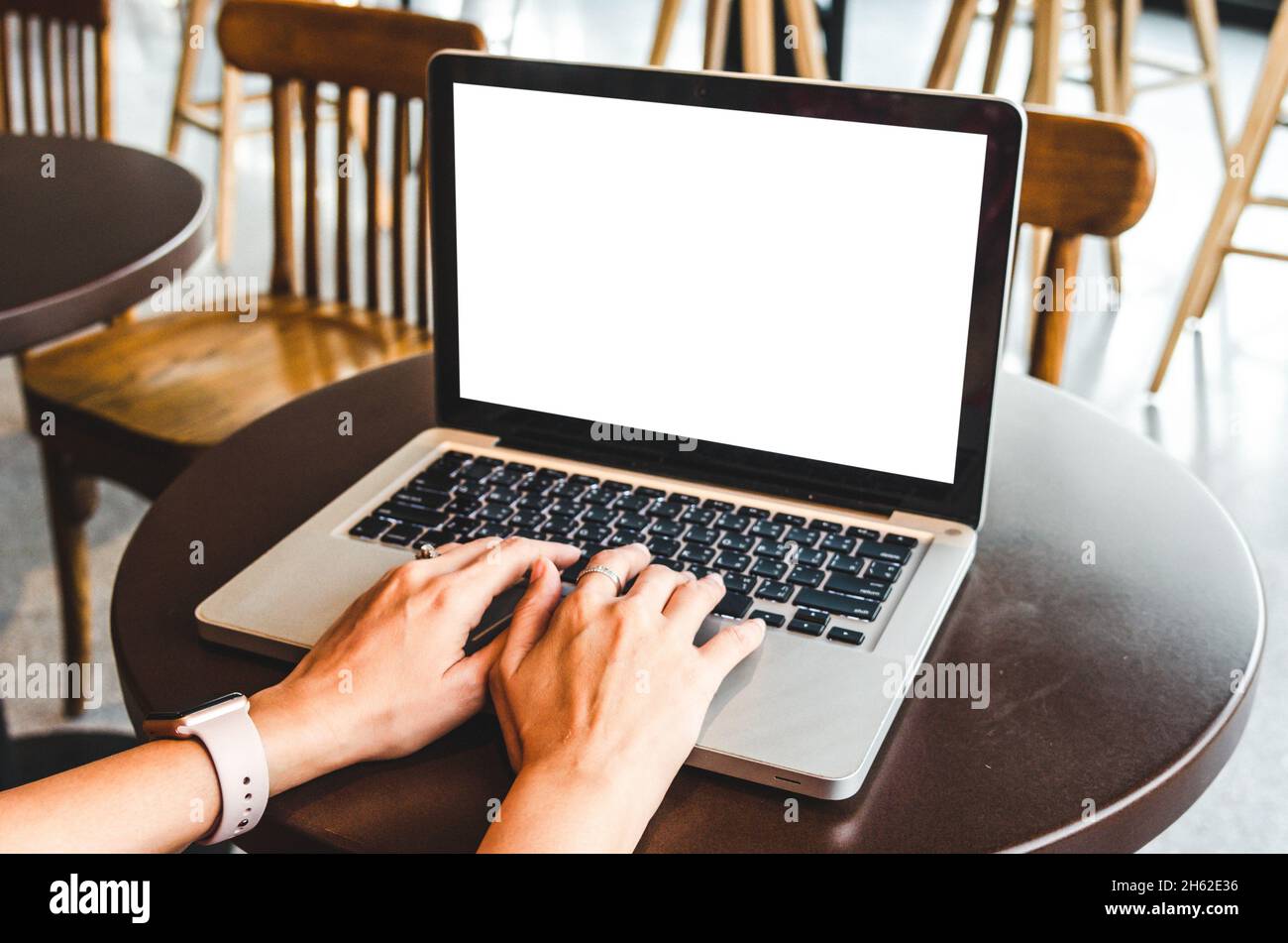 Woman's hands using computer laptop with blank screen on desk Stock ...