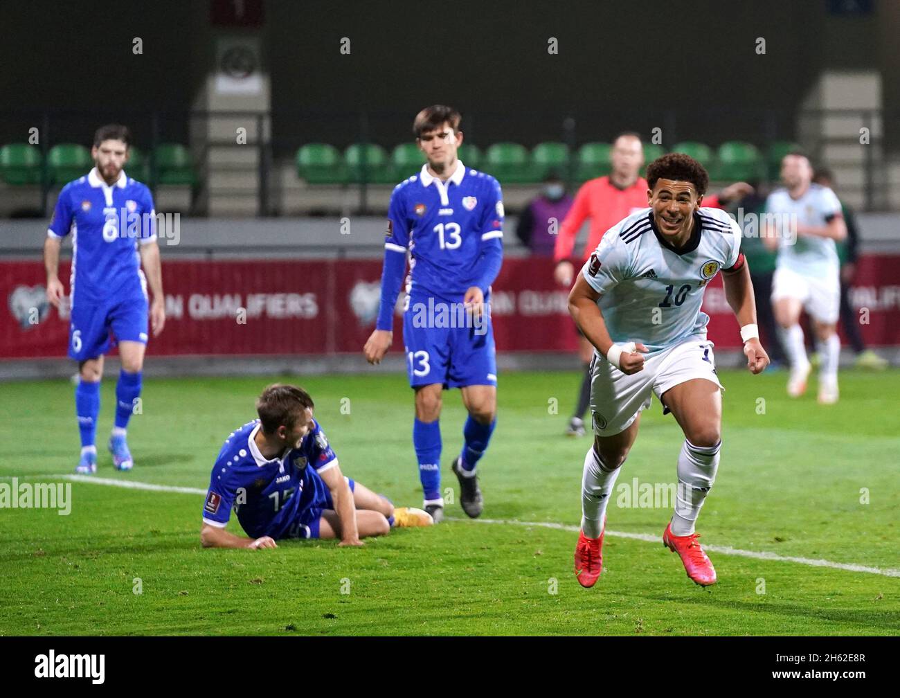 Scotland's Che Adams (right) celebrates scoring their side's second ...