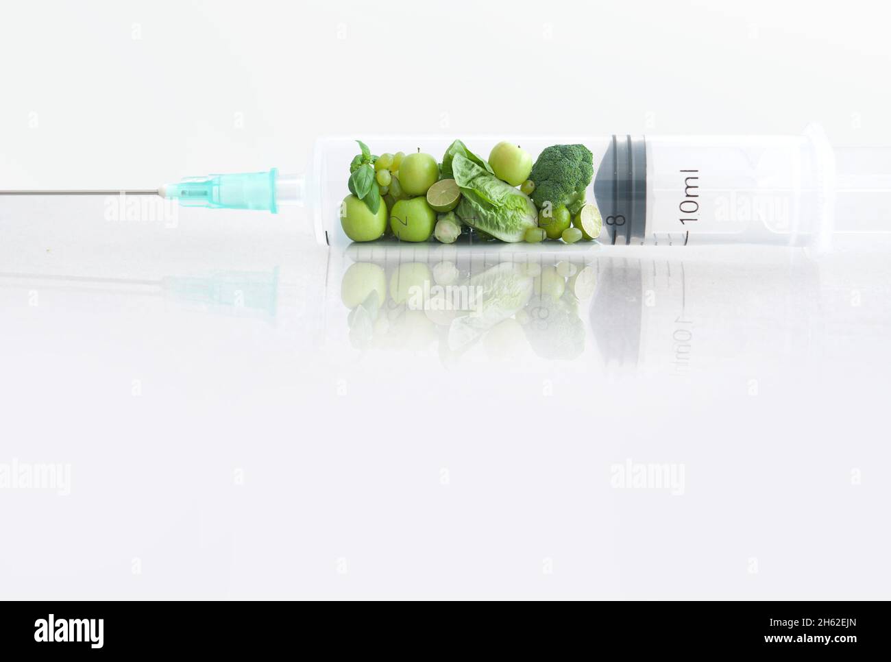 Fruits and vegetables inside an injection needle, nutrition, modified ...