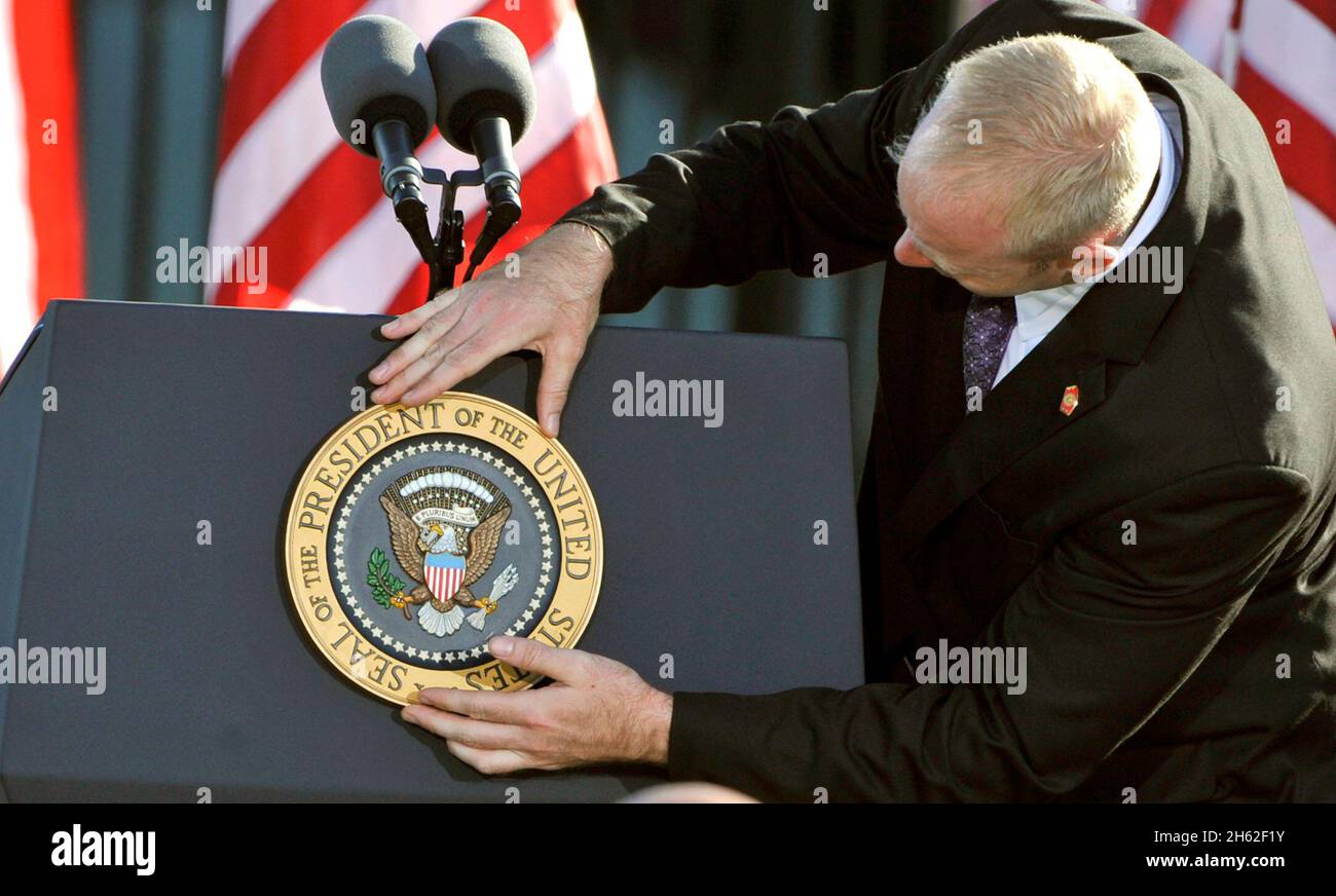 The presidential seal is placed on a lectern before a ceremony at the ...
