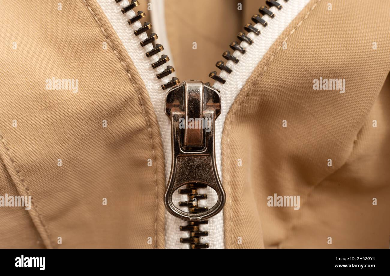 Close-up zip lock on light-colored clothing, jacket. Zipper closure ...