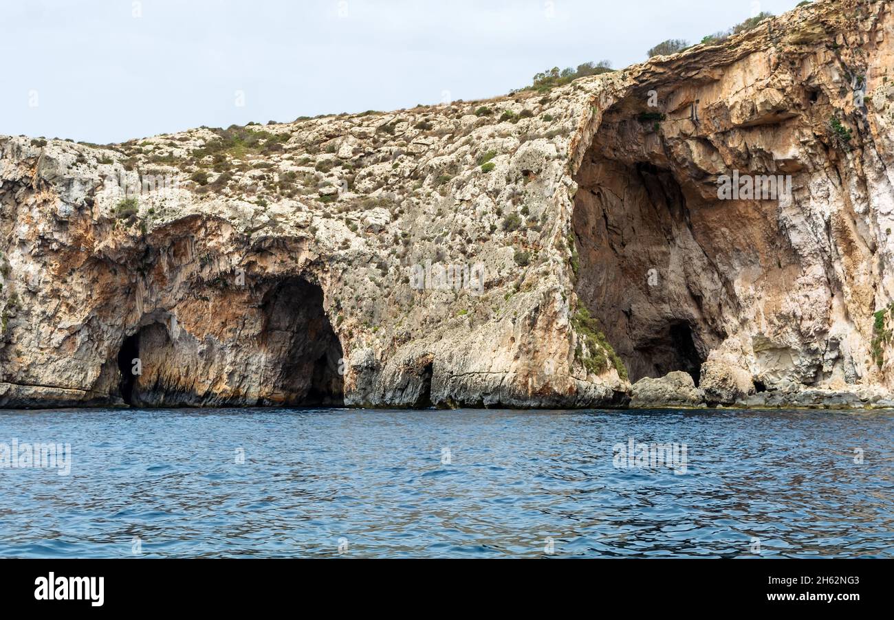 Rocky edges of the Blue Grotto, Malta, sticking out from Mediterranean ...