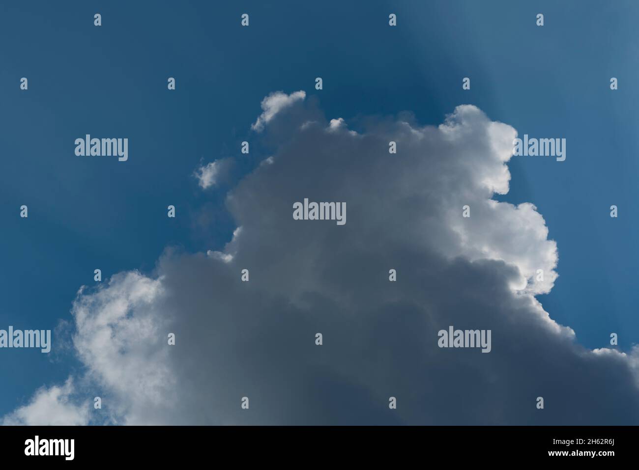 large rain clouds in the sky,sun behind the cloud Stock Photo - Alamy