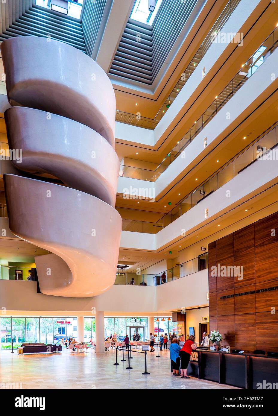 The grand atrium with skylights, and a dramatic spiral staircase in the ...