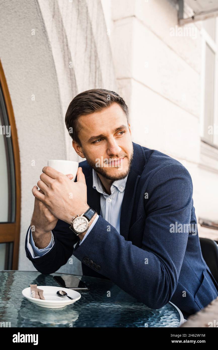 Man like coffee. Handsome man with cup of coffee in cafe. Morning ...