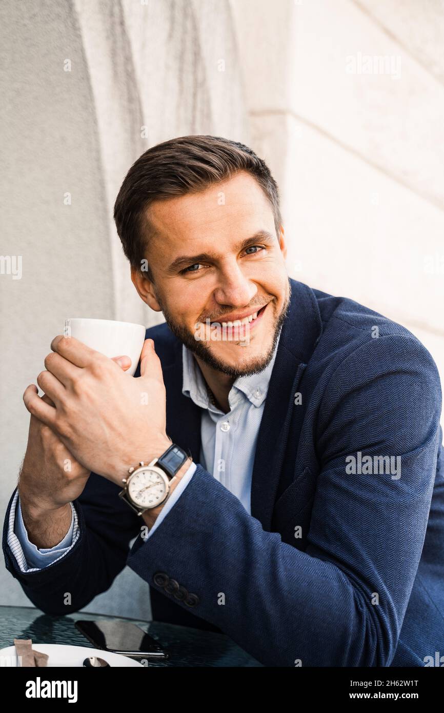 Man like coffee. Handsome man with cup of coffee in cafe. Morning ...
