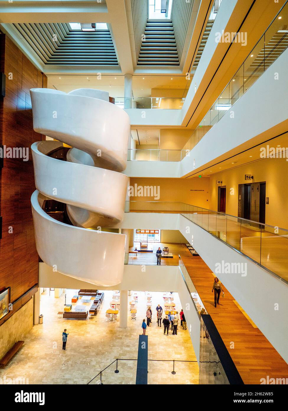 The grand atrium with skylights, and a dramatic spiral staircase in the ...