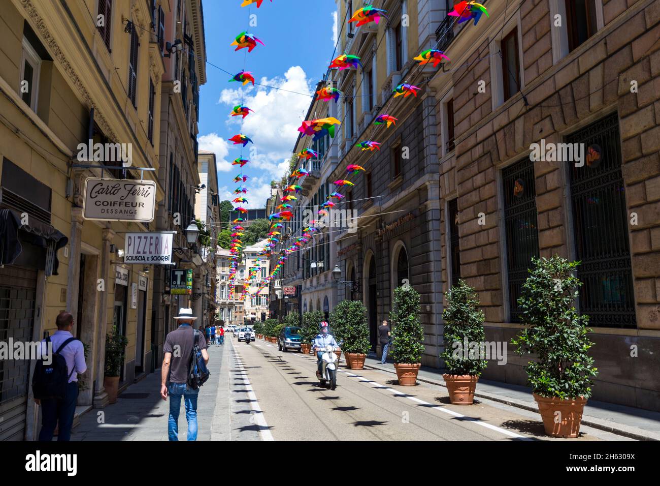 via roma street in genoa,italy,decorated with colorful umbrellas on top ...