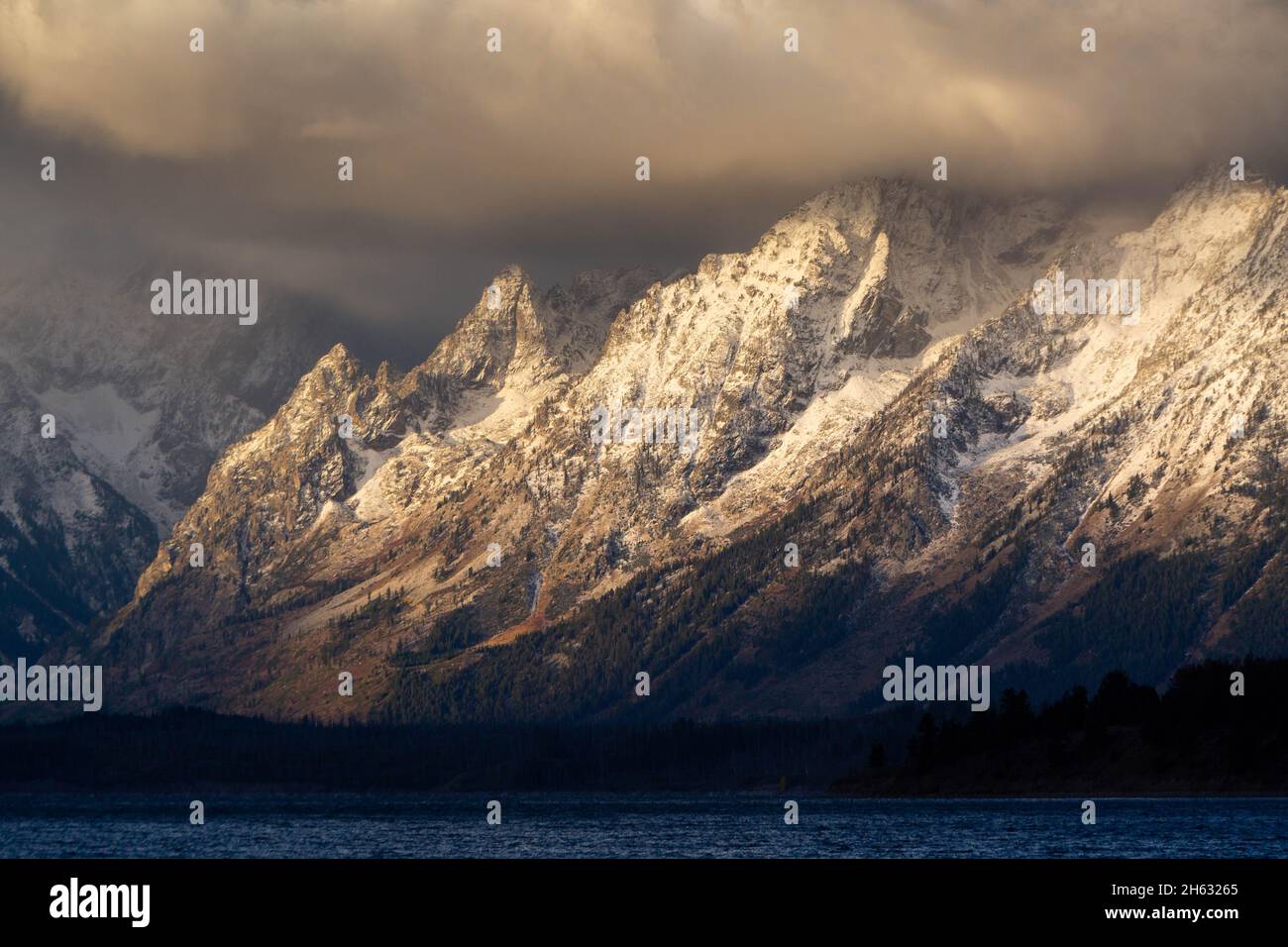 Stormy weather moving in over the Teton Mountains and Jackson Lake creating dramatic light ...