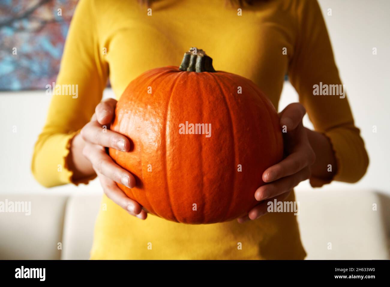 Halloween pumpkin held by a teenage girl in autumn Stock Photo - Alamy
