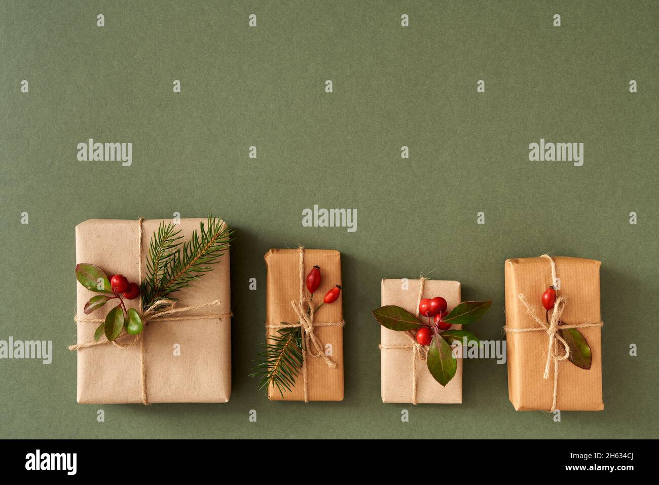 Christmas presents wrapped in ecological recycled paper with ...