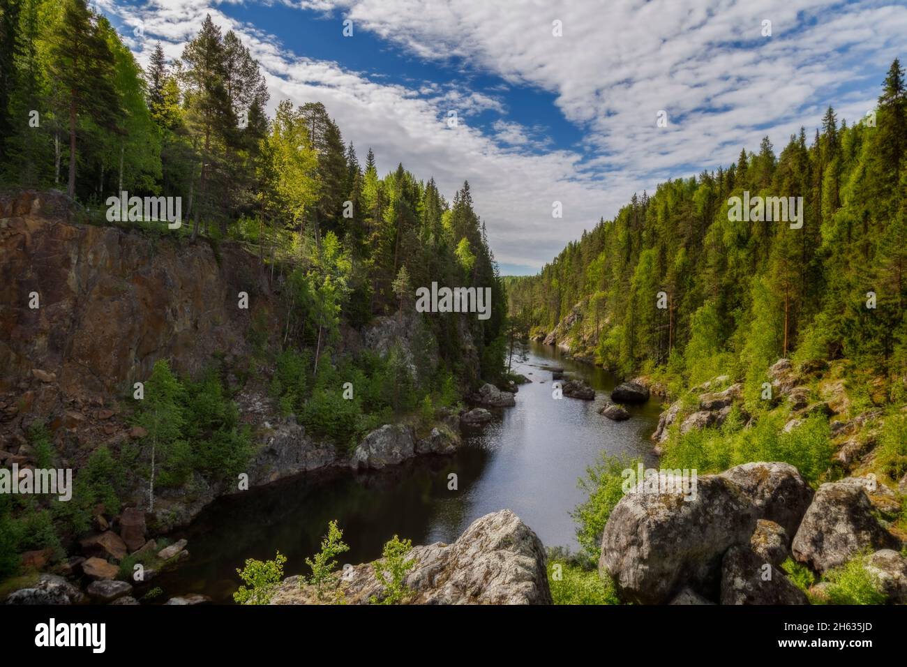 river between mountains with boulders and blue sky with clouds Stock ...