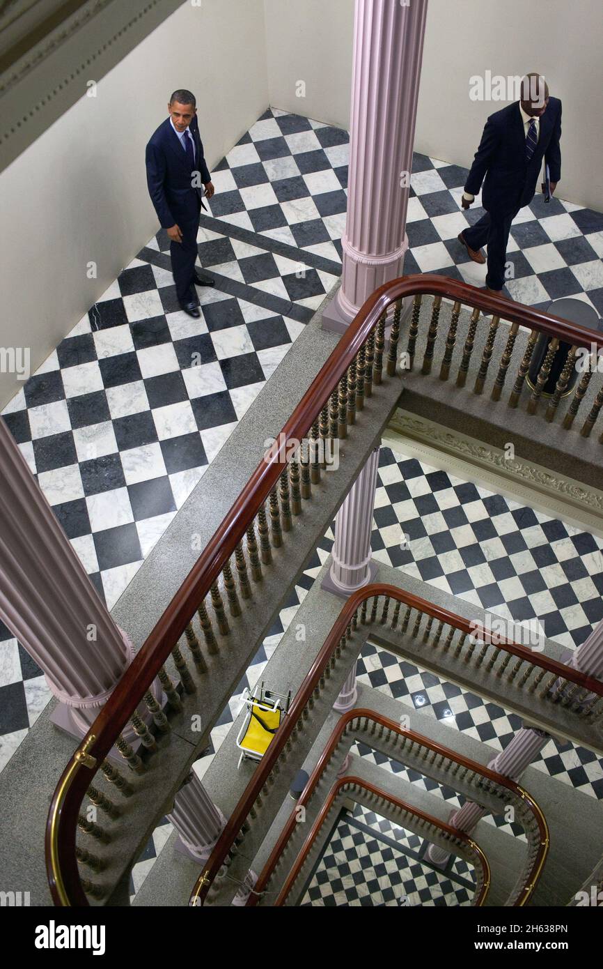 President Barack Obama and personal aide Reggie Love stand in a hallway ...