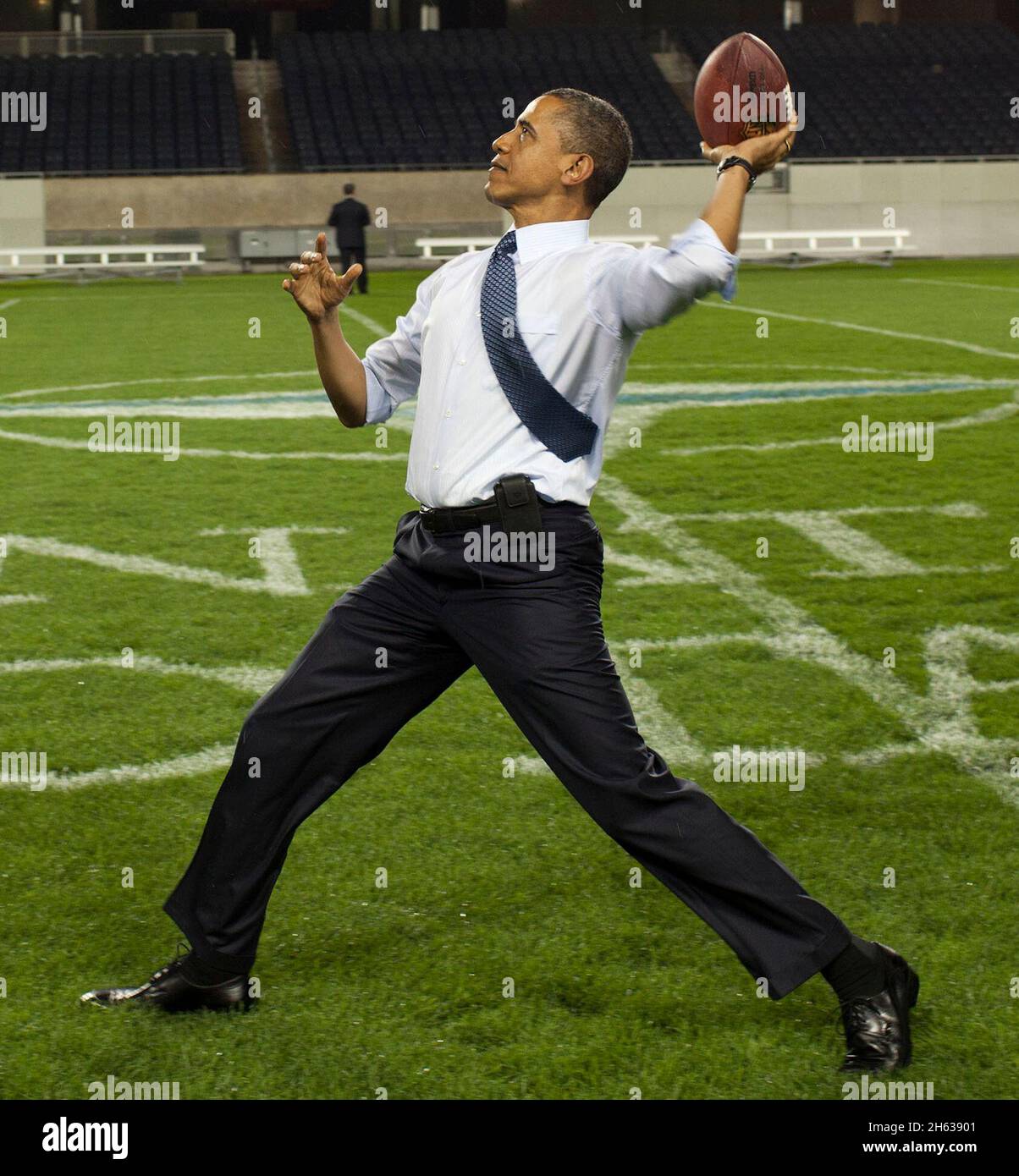 President Barack Obama throws a football on the field at Soldier Field ...