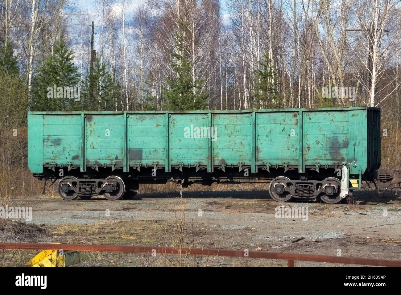 Old green freight train car on rails. Side view Stock Photo - Alamy