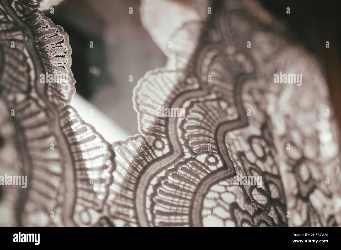 close-up of lace wedding dress in front of window with back light Stock ...